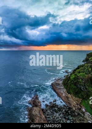 Aerial rainy day sunrise over the ocean at Avoca Beach on the Central ...