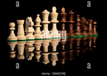 Diagonal line of wooden chess pieces isolated at background with ...