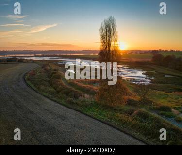 The aerial view of Orwell river and fields under the blue sunset sky in ...