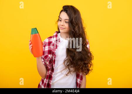 Teenager child girl with bottle shampoo conditioners or shower gel ...