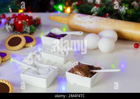 Christmas cookies with jam and hazelnut spread are cooling on wire rack ...