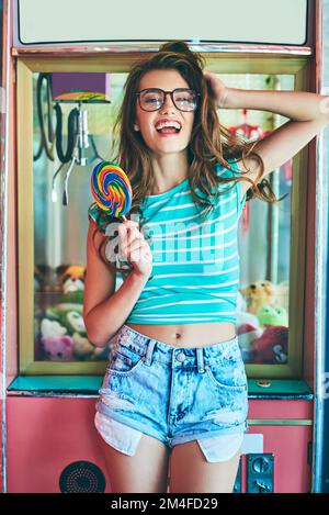 Portrait of young women eating lollipop Stock Photo - Alamy