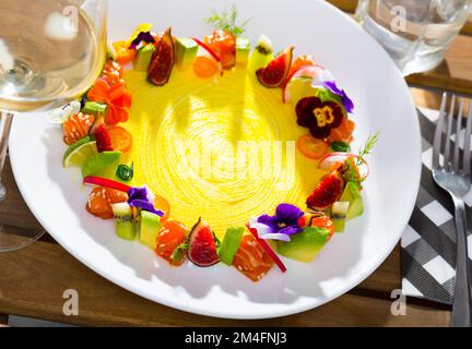 Tartar of raw salmon with ring from avocado and fresh vegetables and ...