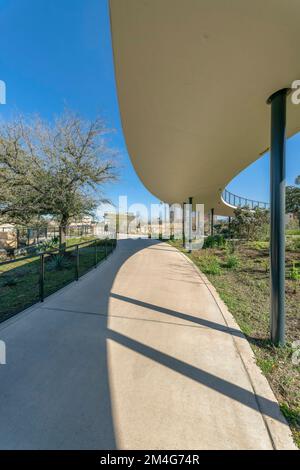 Austin, Texas- Concrete walkway with chainlink railings at Waterloo ...