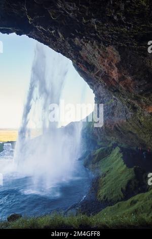 Cave under wonderful waterfall landscape photo Stock Photo - Alamy