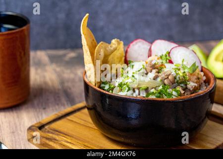 meat in its juice with golden tortilla, toasted, prepared with radishes ...