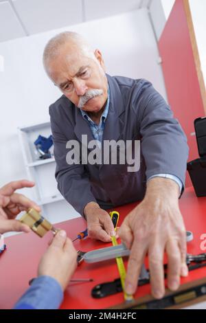 door handle measurement, man measuring the door with a tape measure ...