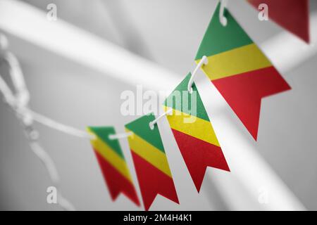 A garland of Congo national flags on an abstract blurred background ...
