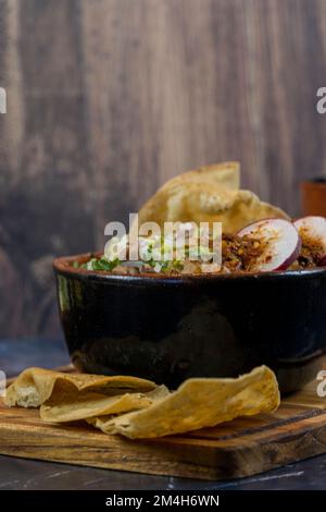 meat in its juice with golden tortilla, toasted, prepared with radishes ...