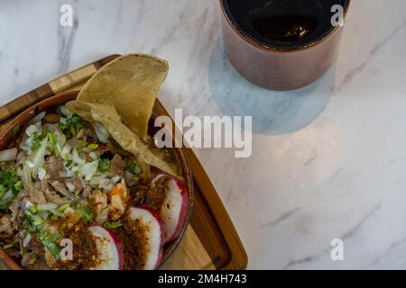 lemons for meat dish in its juice with corn tortilla chips, glass with ...