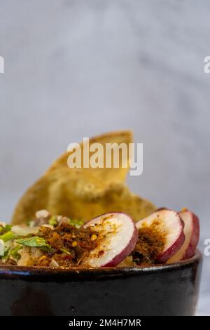 meat in its juice with golden tortilla, toasted, prepared with radishes ...