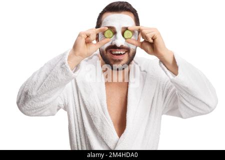 Man with a face mask and cucumber over eyes relaxing on a lounge chair ...