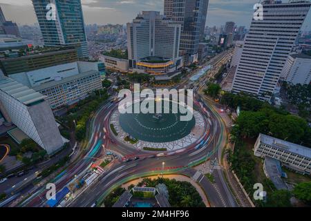 An aerial view of cityscape Jakarta surrounded by buildings with light ...
