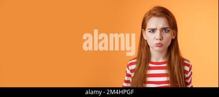 Childish offended cute redhead girl pouting, sulking upset, frowning ...