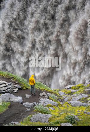 Tourist standing at a canyon, canyon with falling water masses ...