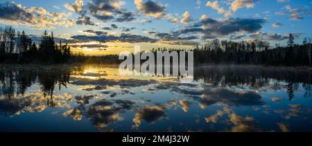 Morning mists at sunrise on a beaver pond in early spring, Greater ...