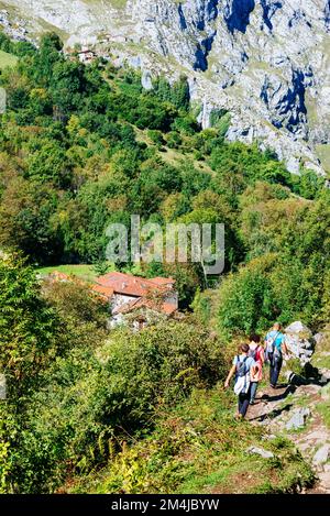 Tourists on a trail in the vicinity of Bulnes de Abajo, La Villa, in ...
