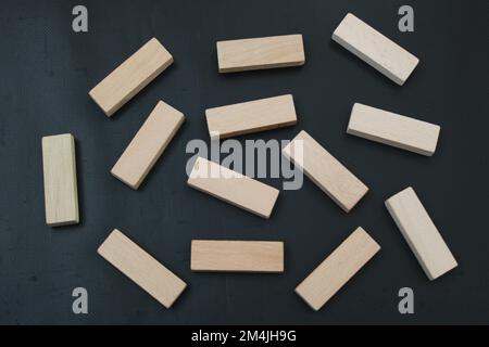 wooden blocks lined up in rows on black background Stock Photo - Alamy