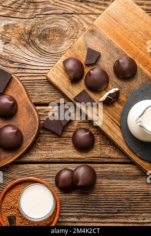 Cutting boards with sweet bird's milk candies, jugs of milk and ...