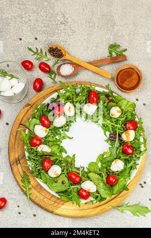 Charcuterie wreath made with mozzarella, cherry tomatoes and arugula ...