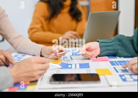 Closeup image of software developers discussing programming code ...