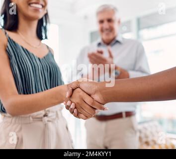 business partners shaking hands with the applause of the business team ...