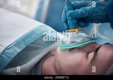 Anesthesia, oxygen mask and medical with man in surgery for breathing ...