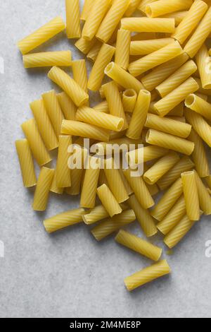 Flat lat of uncooked tortiglioni pasta shells, top view of tortiglioni ...