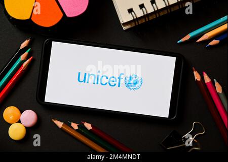 In this photo illustration, a Unicef logo seen displayed on a ...