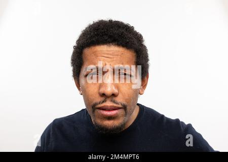 adult with glasses straining his eyes because he can't see, isolated ...