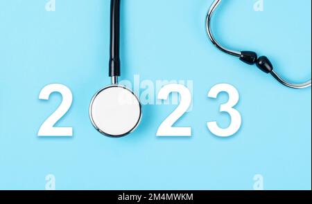 Stethoscope with number 2023 on yellow background. Happy new year for ...