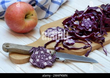 Red cabbage, sliced red cabbage with knife and apple Stock Photo - Alamy