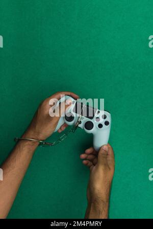 Video game joystick and handcuffs isolated. Addiction to games concept ...