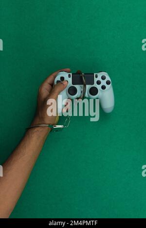 Video game joystick and handcuffs isolated. Addiction to games concept ...