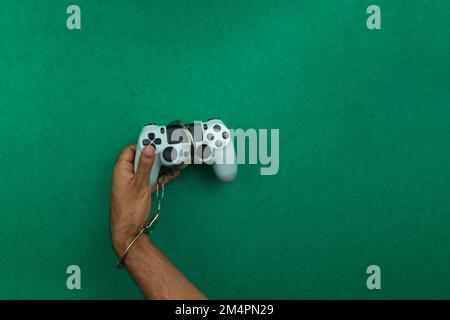 Video game joystick and handcuffs isolated. Addiction to games concept ...