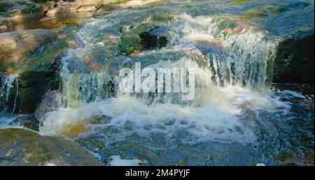 A mesmerizing waterfall and river on a sunny day in summer Stock Photo ...