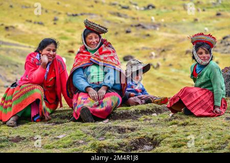 Indigenous Quechua family in local costume inf front of Santo Domingo ...
