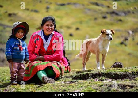 Indigenous Quechua family in local costume inf front of Santo Domingo ...