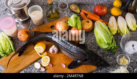 Raw uncooked fish sturgeon at plate with vegetable Stock Photo - Alamy