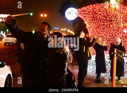 Damascus, Syria. 22nd Dec, 2022. People look at Christmas decorations ...