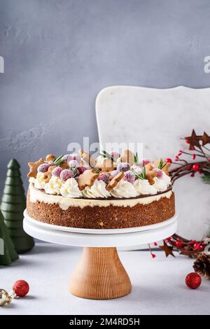 Christmas cake decorated with gingerbread cookies and sugared cranberry ...