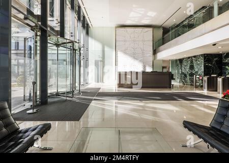Atrium of an office building with green marble tiled walls, cream ...