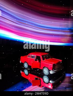 Colorful little toy car in hand on white background Stock Photo - Alamy