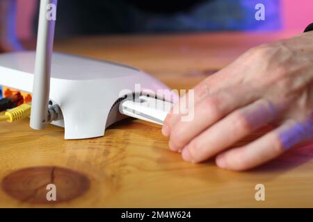 inserting gsm modem into router with antennas on plank table by sosba ...