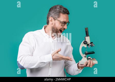surprised man with invention microscope isolated on blue background ...