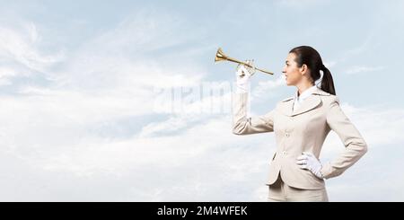 Beautiful woman playing trumpet brass Stock Photo - Alamy