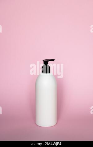 White unbranded bottle with a black dispenser isolated on white ...