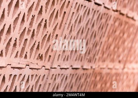 Holey red brick texturte close up Stock Photo - Alamy