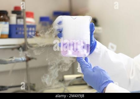 Laboratory experiment with liquid nitrogen in laboratory mortar with ...