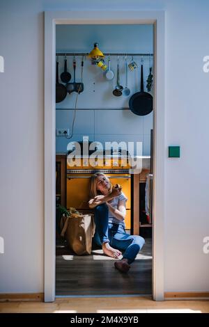 Woman Sitting On Kitchen Floor With Spilled Food Stock Photo - Alamy